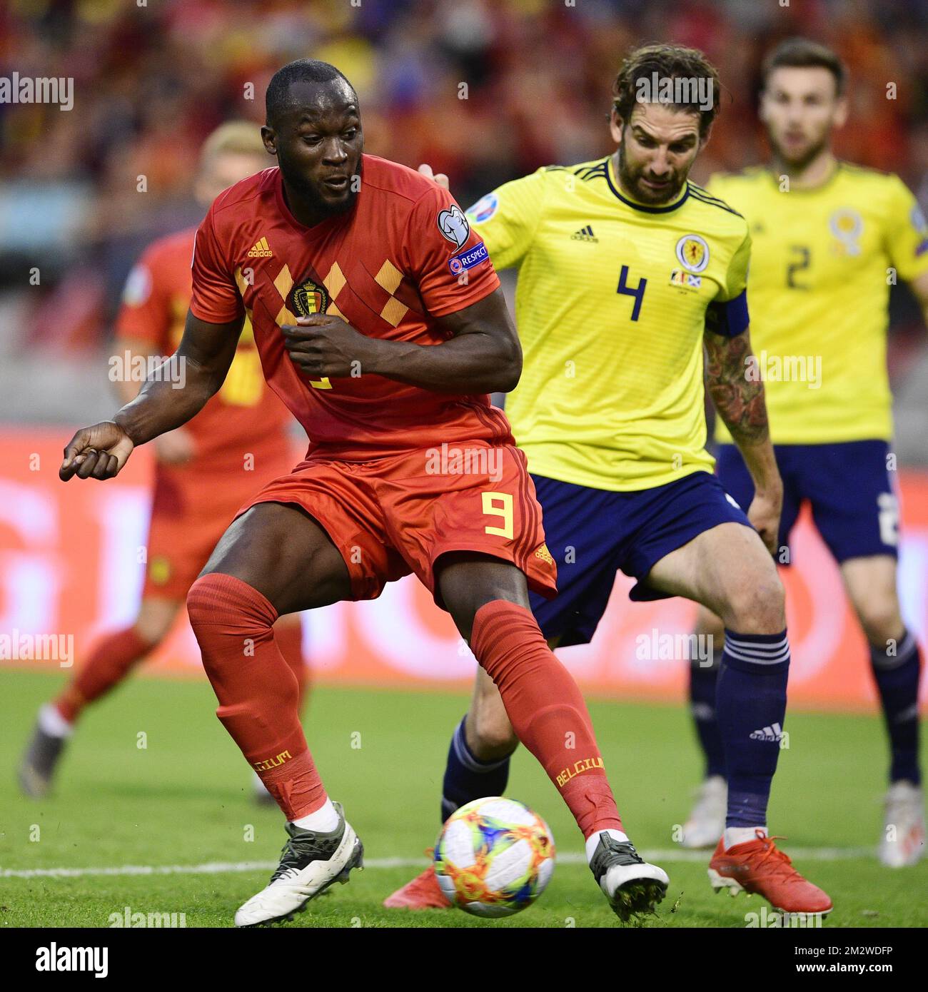 Belgium's Romelu Lukaku and Scotland's Charlie Mulgrew fight for the ...