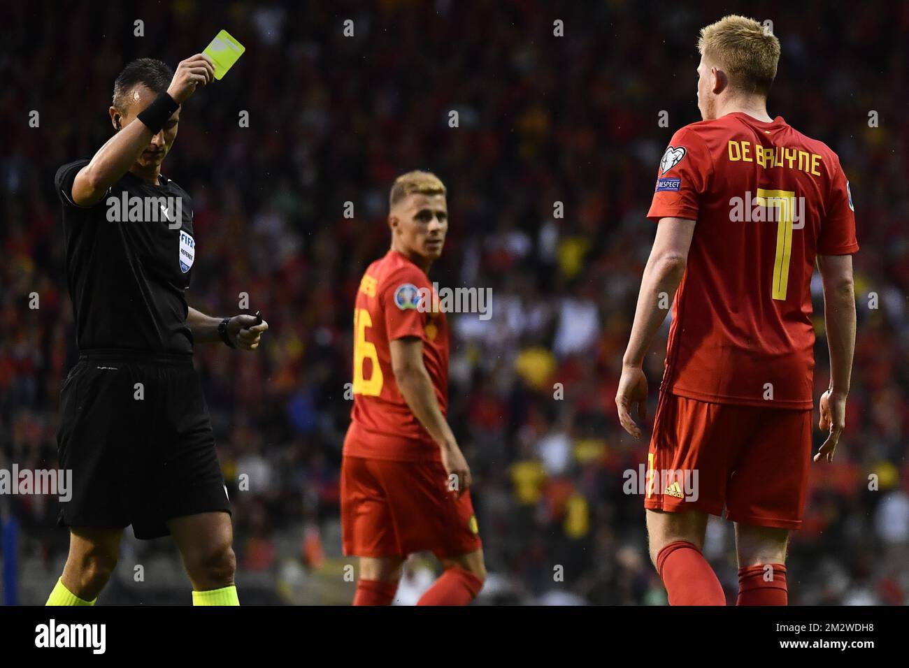 Czech referee Petr Ardeleanu gives a yellow card to Belgium's Kevin De ...