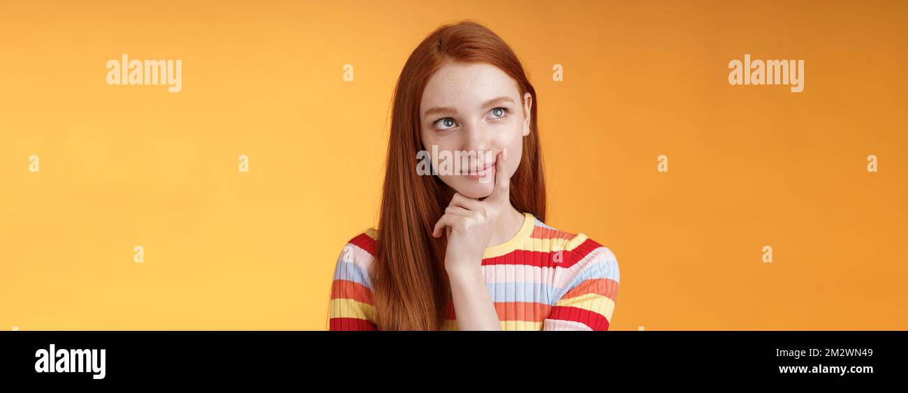 Creative thoughtful young smart redhead female student thinking ideas ...