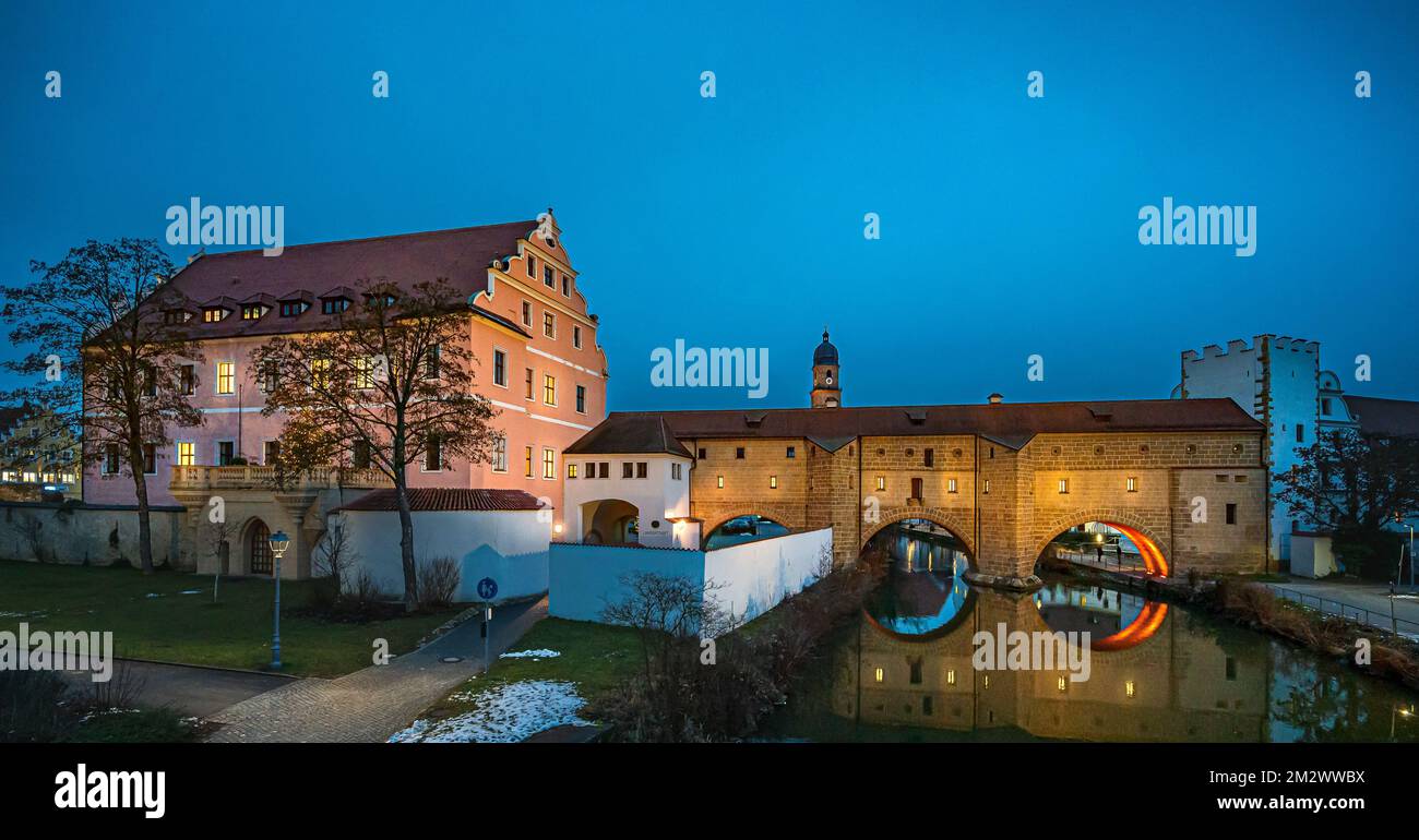 The Stadtbrille bridge over the river Vils in the evening with the ...