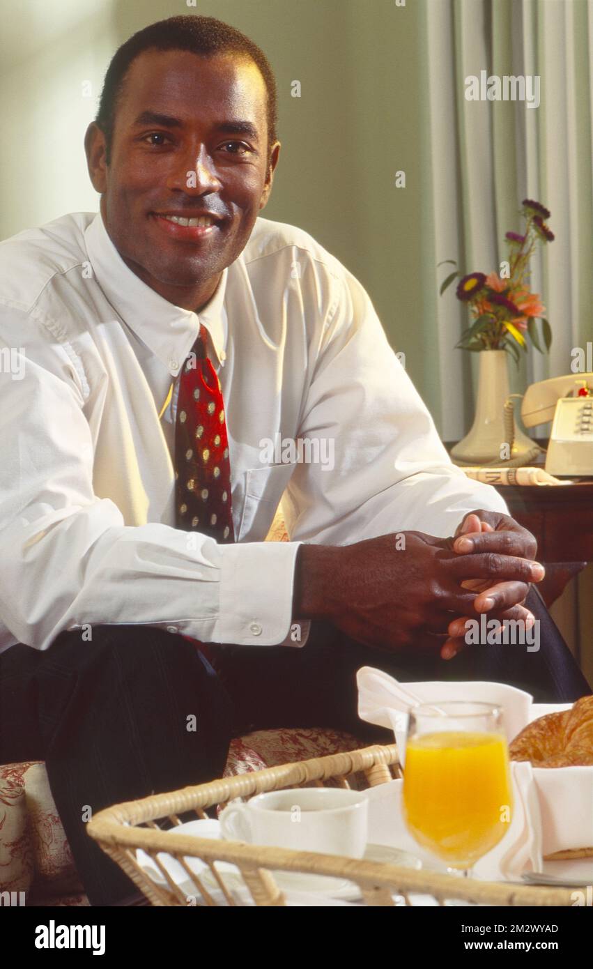 African-American business man pausing from hotel breakfast for a ...