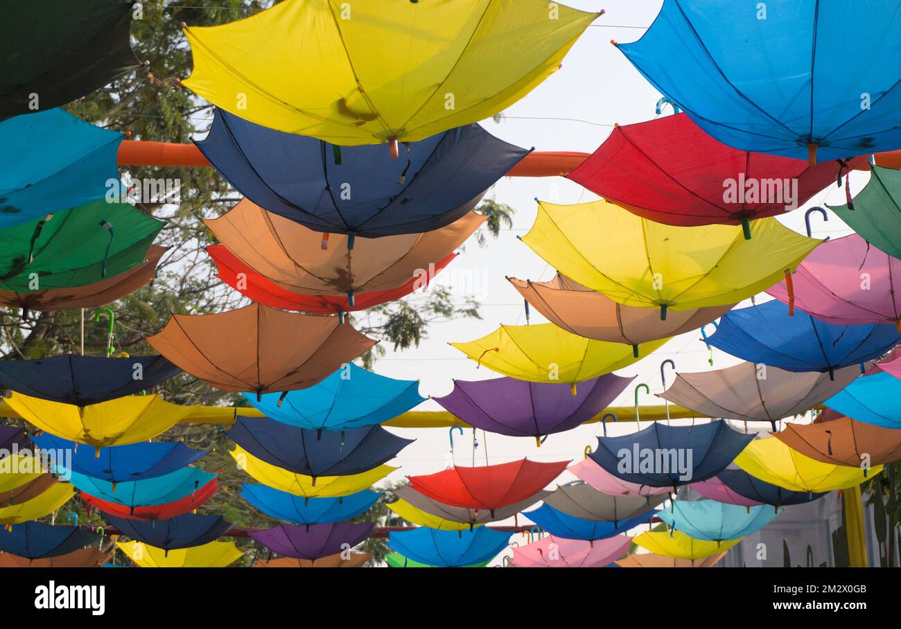 Upside down Multicolored rainbow umbrellas hanging above as street art ...