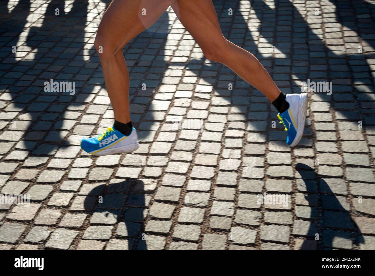 Running Race, Male Feet on Porphyry Cobblestone Stock Photo - Alamy