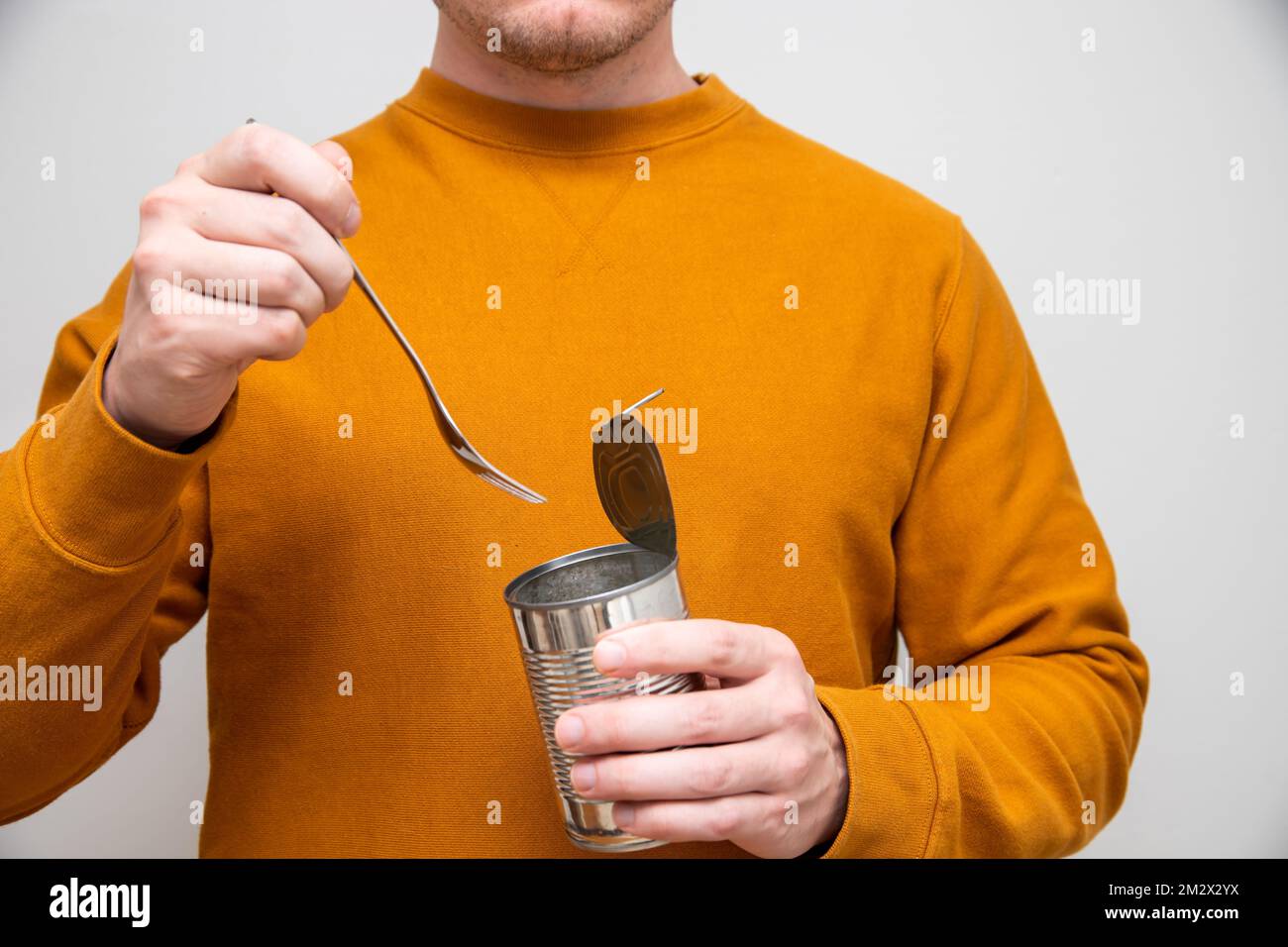 Man eating canned food hi-res stock photography and images - Alamy