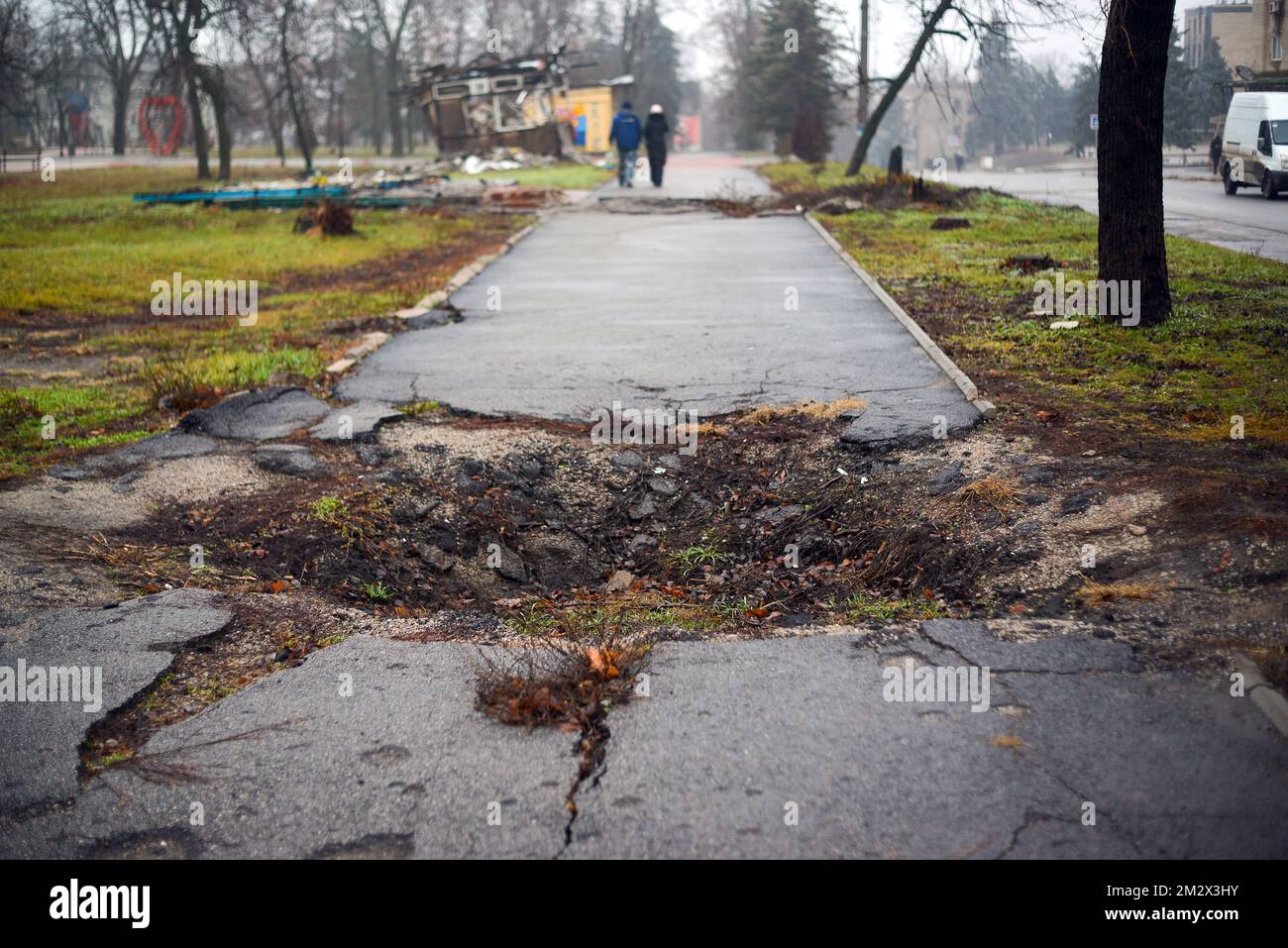 KHARKIV REGION, UKRAINE - DECEMBER 13, 2022 - A shell crater is seen in ...