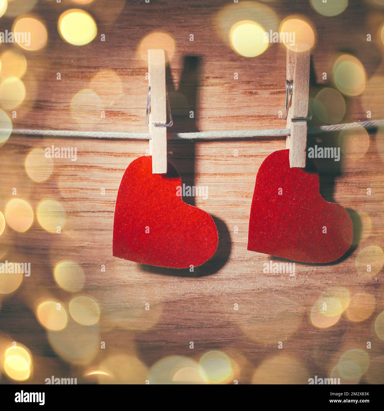 two red hearts on clothespins on wooden background. beautiful bokeh ...