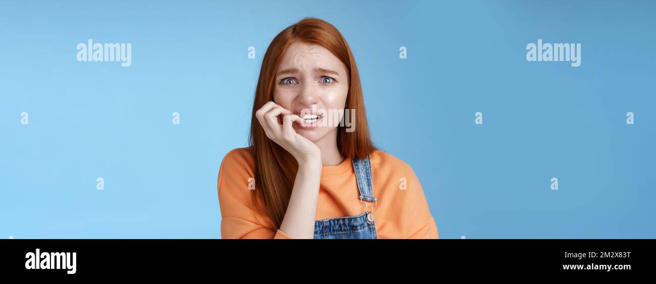 Intense worried scared unsure young redhead panicking silly girl ...