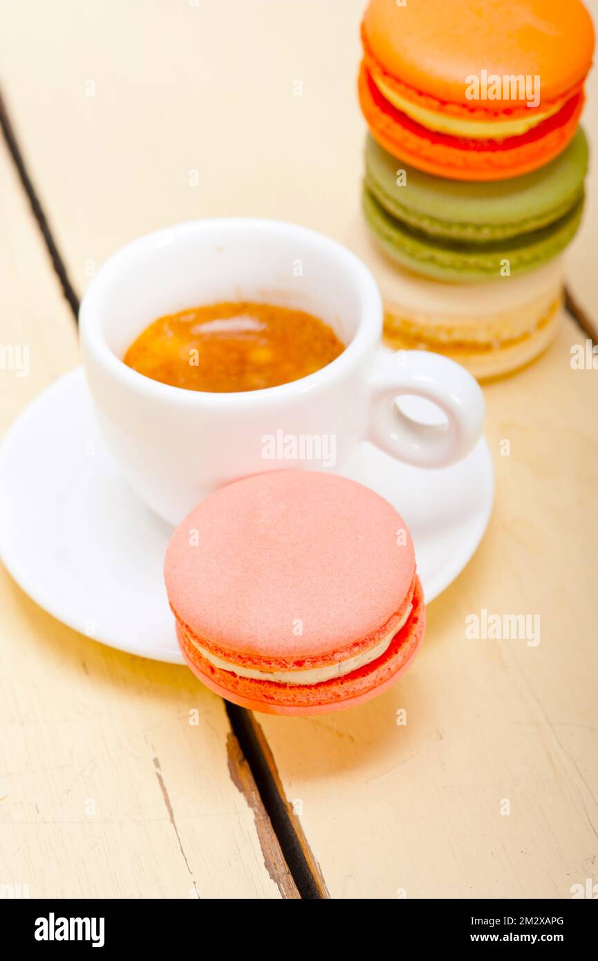 Colorful macaroons with espresso coffee over white wood table Stock ...