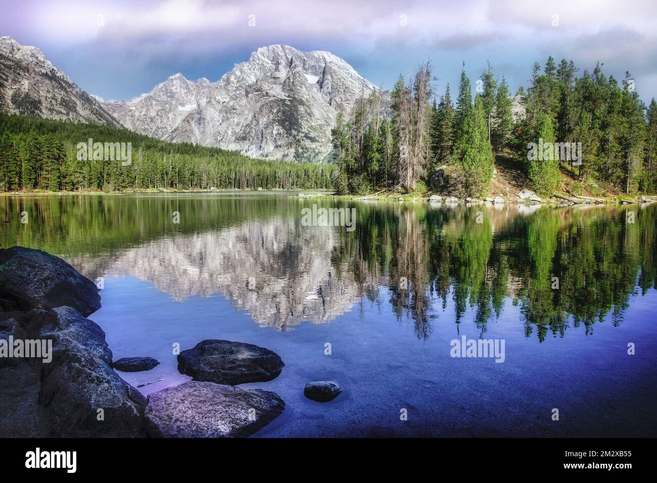 Mount Moran reflects in Leigh Lake in Grand Teton National Park ...