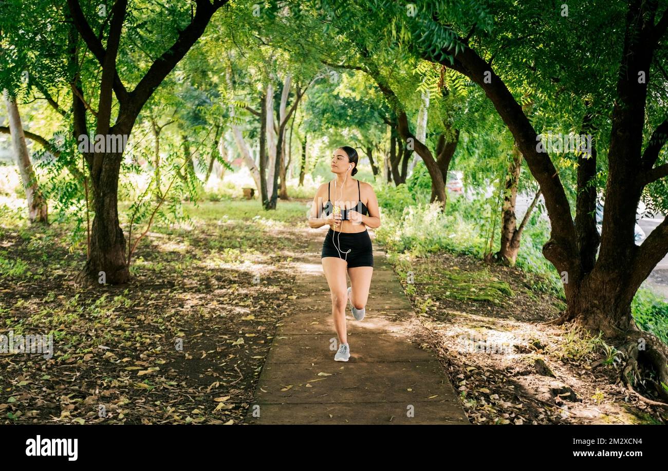 Girl running in a park hi-res stock photography and images - Alamy