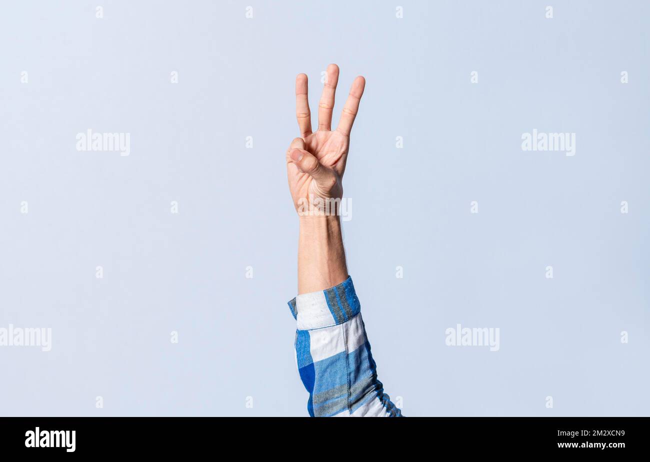 Hand gesturing the letter W in sign language on an isolated background ...
