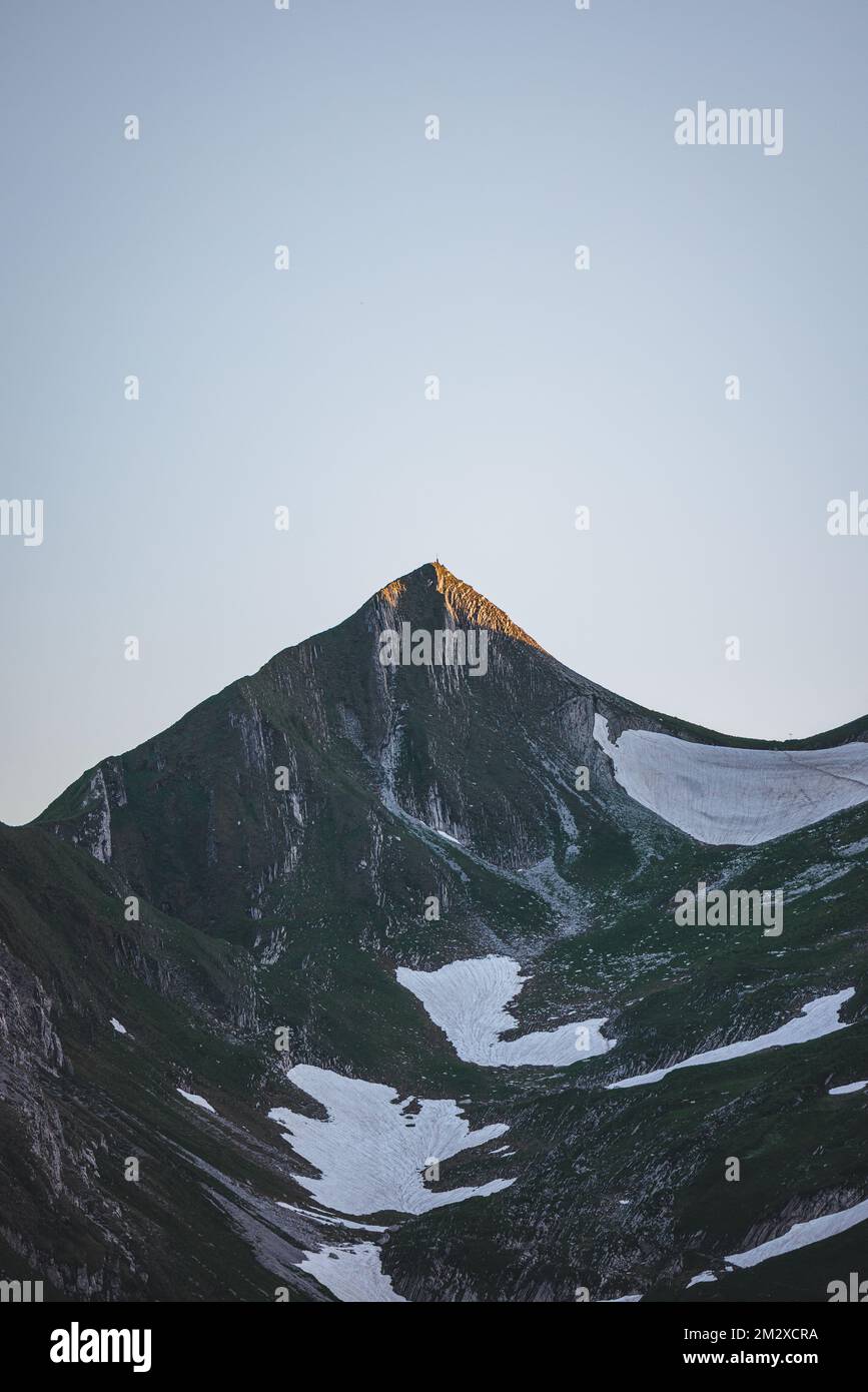 A vertical shot of a snowy mountain against a blue sky Stock Photo - Alamy