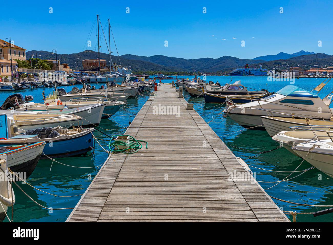 Jetty and anchored fishing boats in the harbour of Portoferrraio, Elba ...
