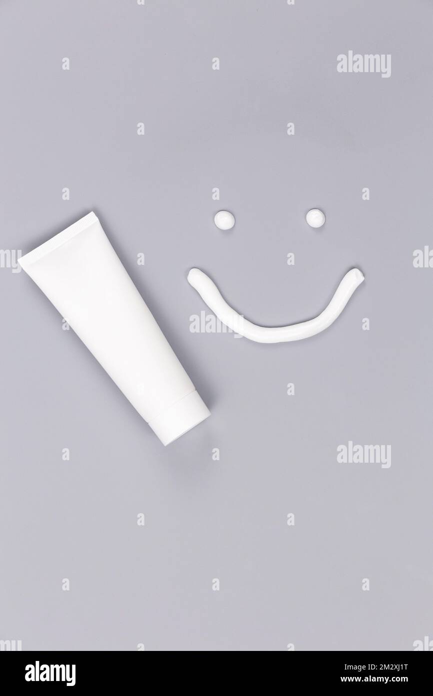 Smile made of toothpaste tube next to it Stock Photo - Alamy