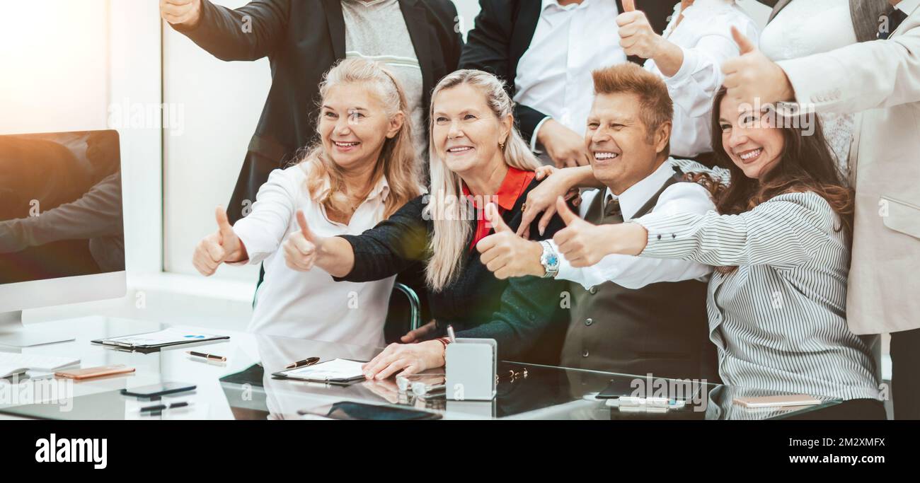 group of happy corporate employees showing thumbs up Stock Photo - Alamy