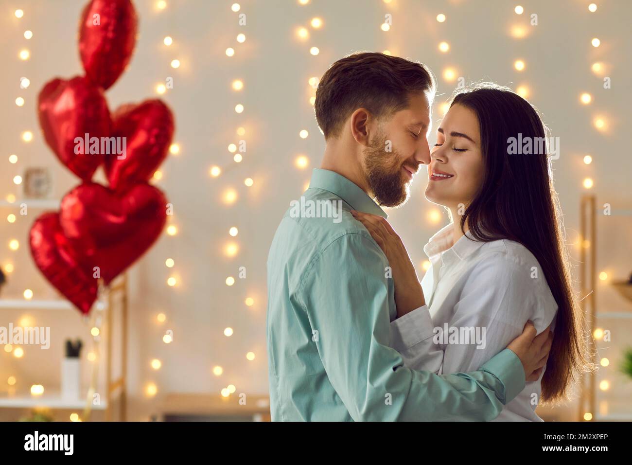 Happy young loving couple celebrating Valentine's Day, hugging, dancing ...