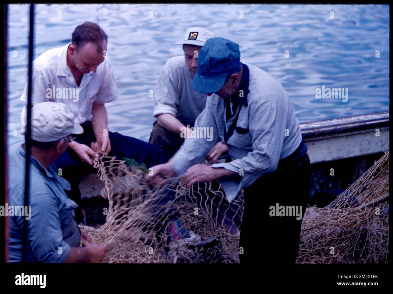Fisherman mending nets , Fishermen. Edmund L. Mitchell Collection Stock ...