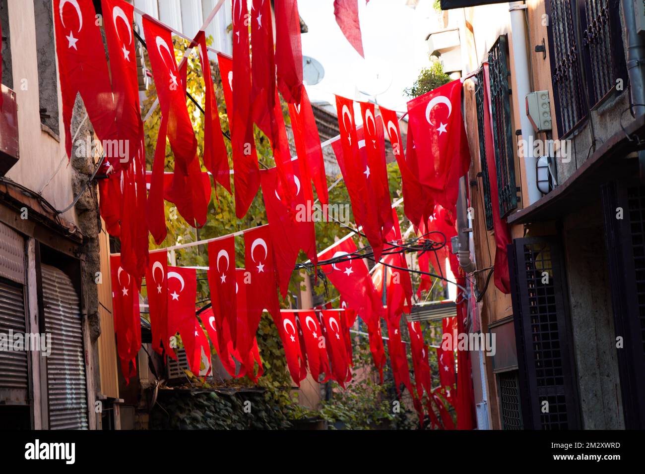 Turkish national flag hang on a pole on a rope in the street in open ...