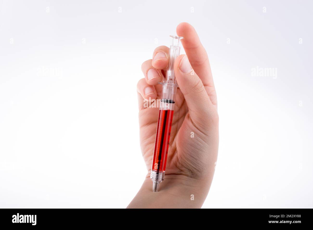 Hand holding injection to itself on a white background Stock Photo - Alamy