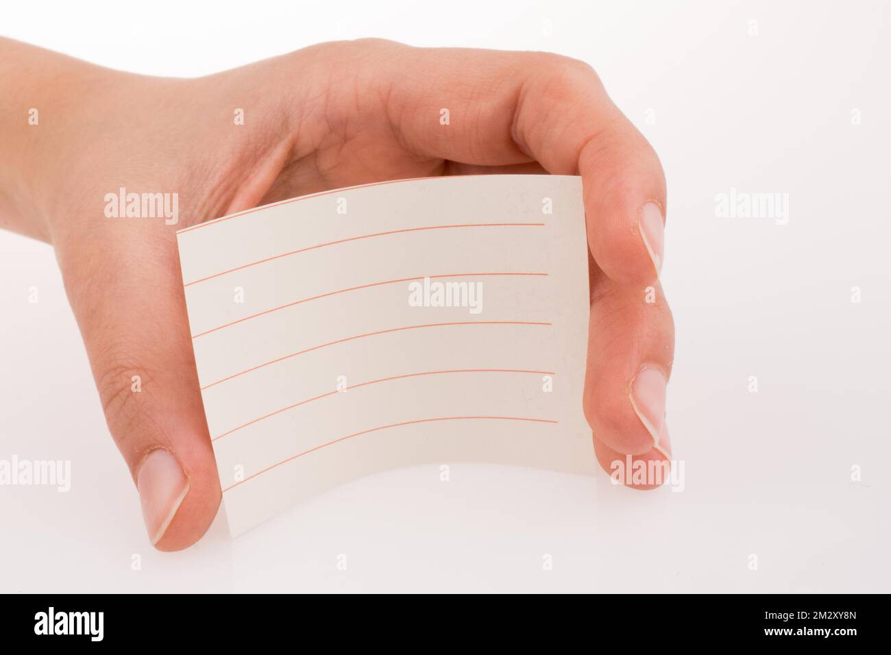 Hand holding a piece of lined paper on a white background Stock Photo ...