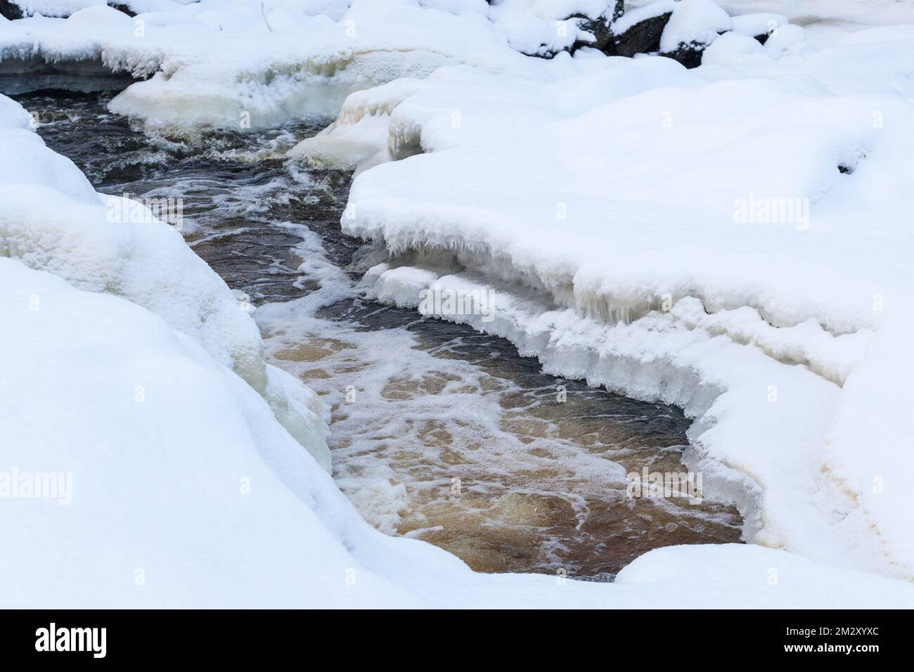 Ice and snow on a frozen river Stock Photo - Alamy