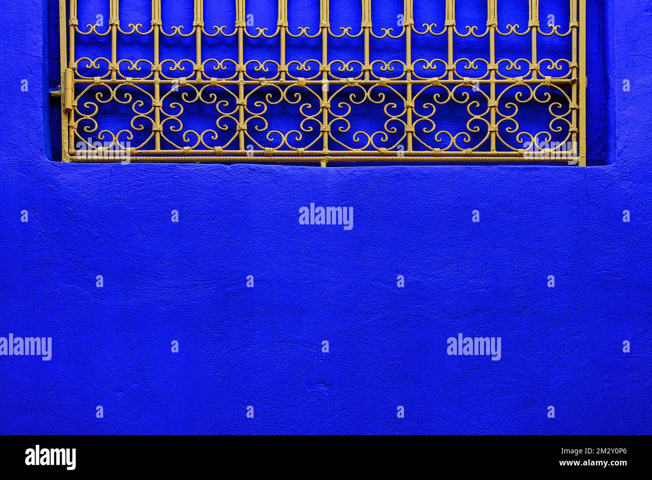 Ornate window grille in a blue wall, arabesque, Jardin Majorelle ...