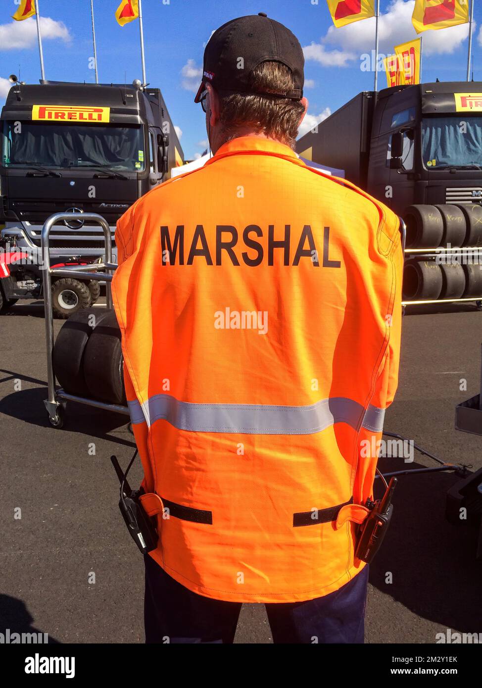 Track marshal of international car race is dressed in orange jacket ...