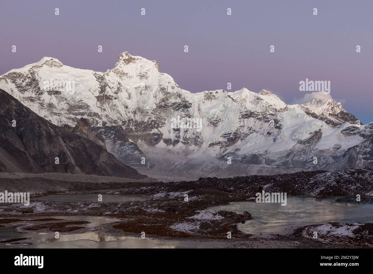 Dramatic snowy peak of Mount Cholatse rising above moraine lakes area ...