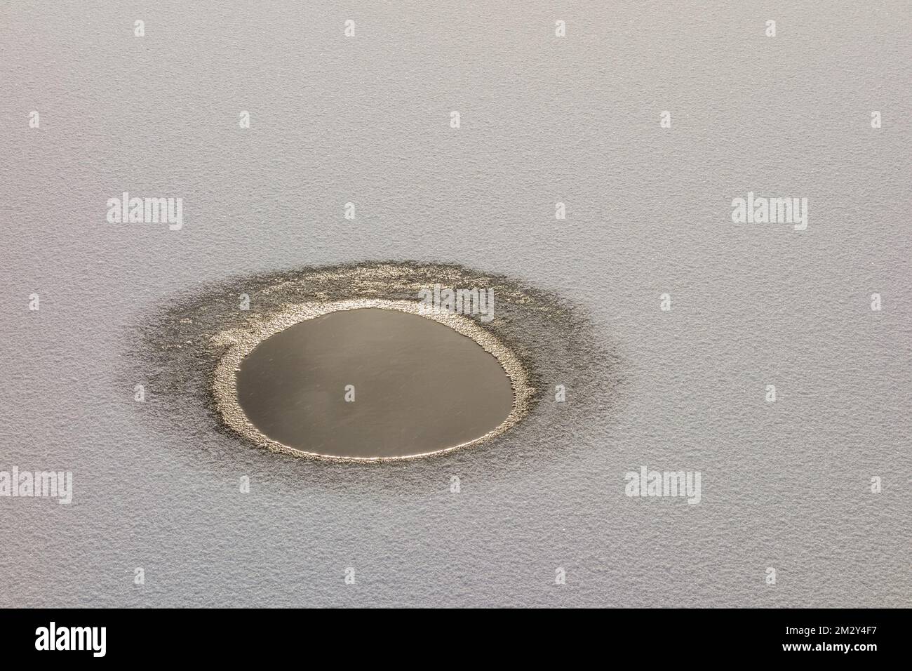 Melted water puddle on the lake Stock Photo - Alamy