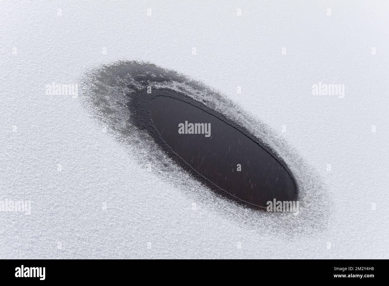 Melted water puddle on the lake Stock Photo - Alamy