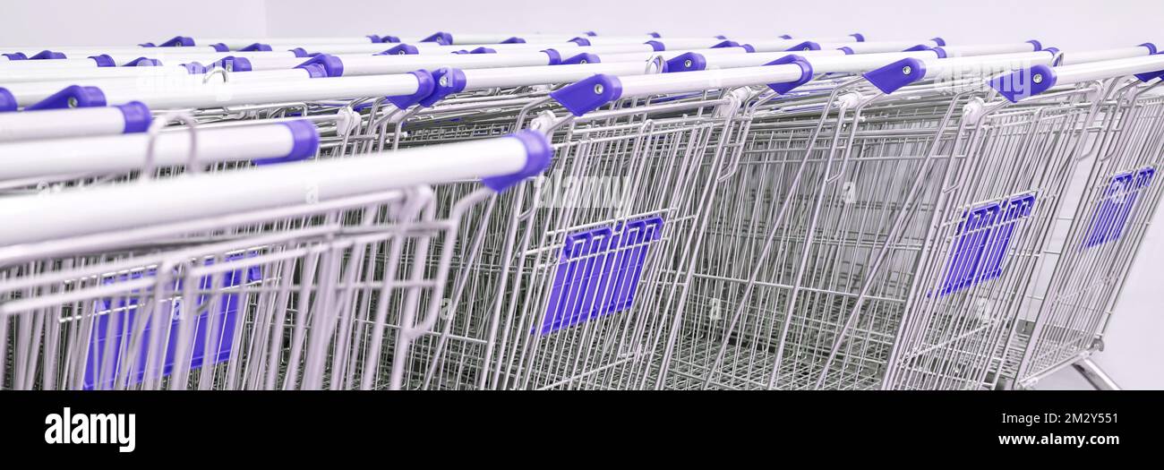 Many same shop trolley. Retail consumer carts. Empty parking store mall ...