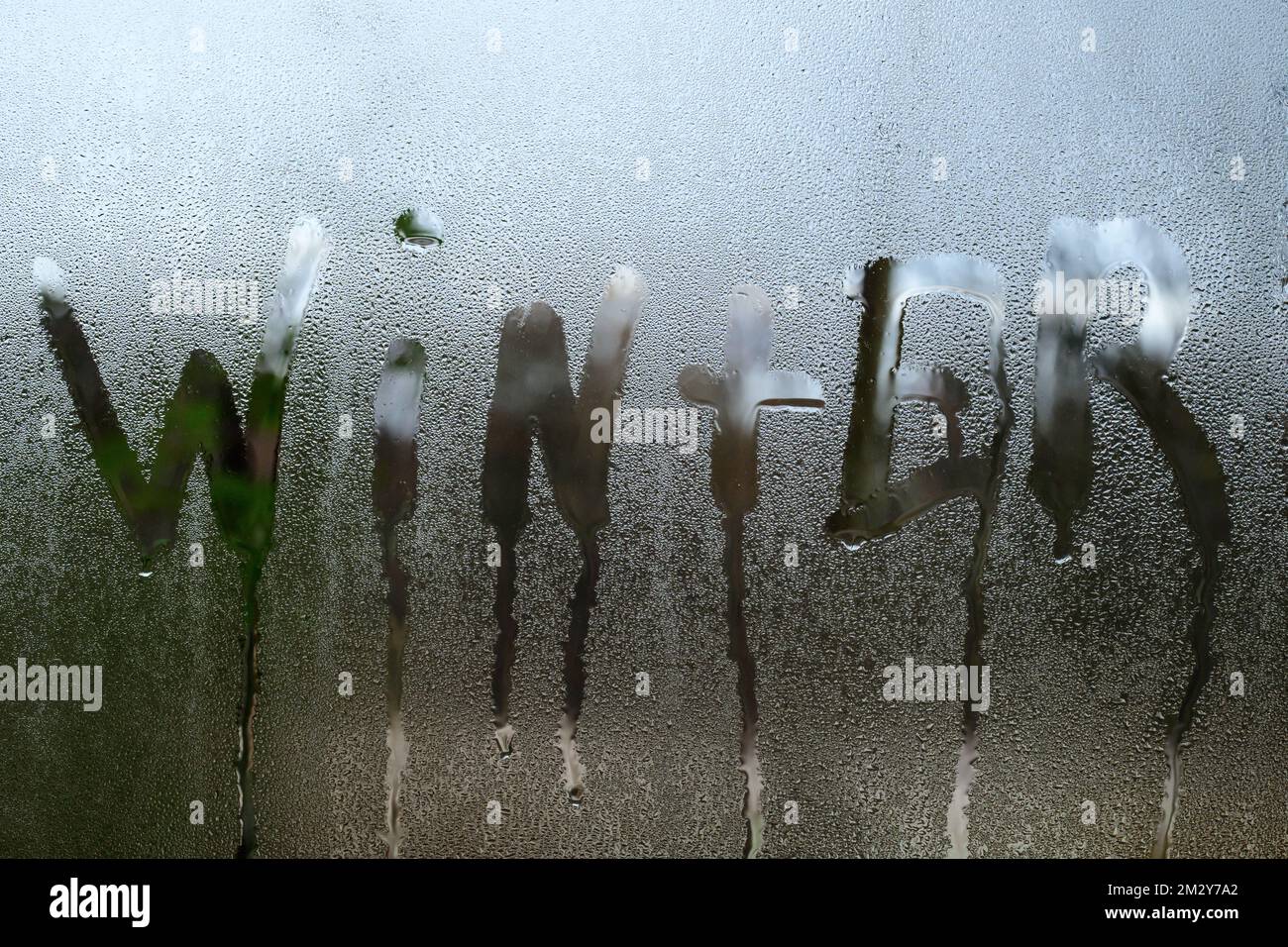 The inscription winter is painted on glass with condensation, the ...