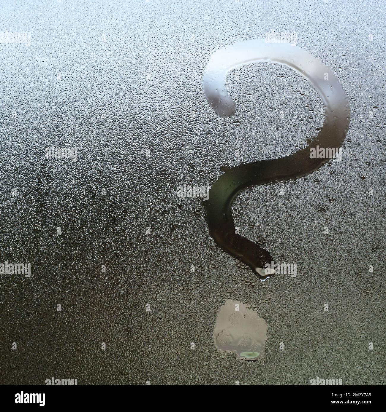 Fogged glass, a question mark is written on the window with ...