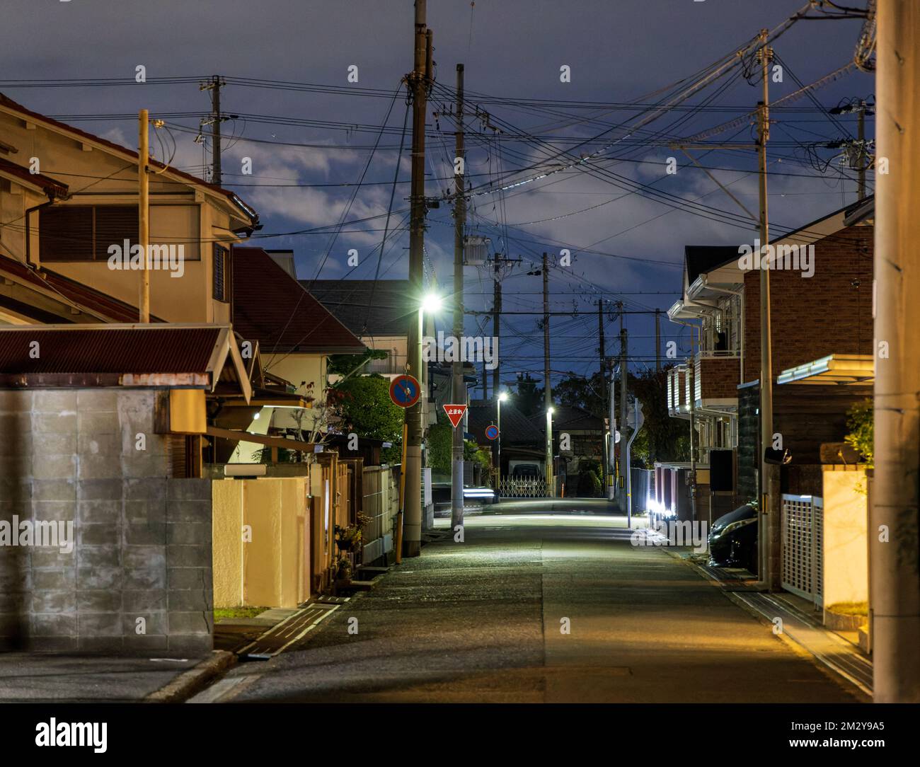 Empty street through quiet Japanese neighborhood at night Stock Photo ...