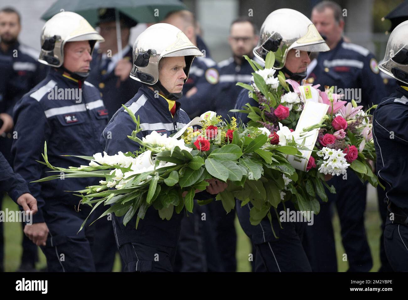 Illustration picture shows firefighters carrying flower wreaths, at a ...