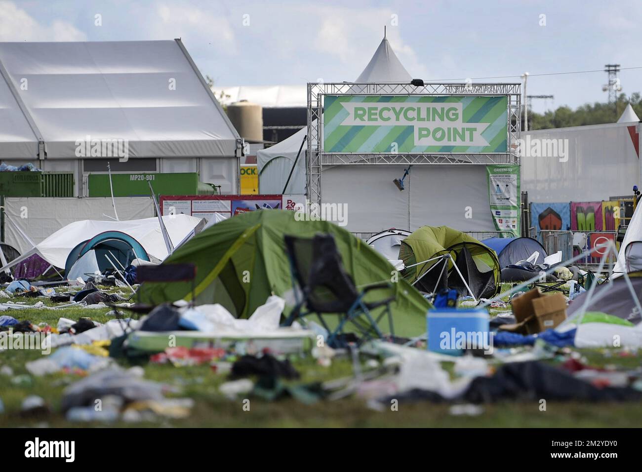 Illustration shows abandoned tents and garbage in front of a 'recycling ...