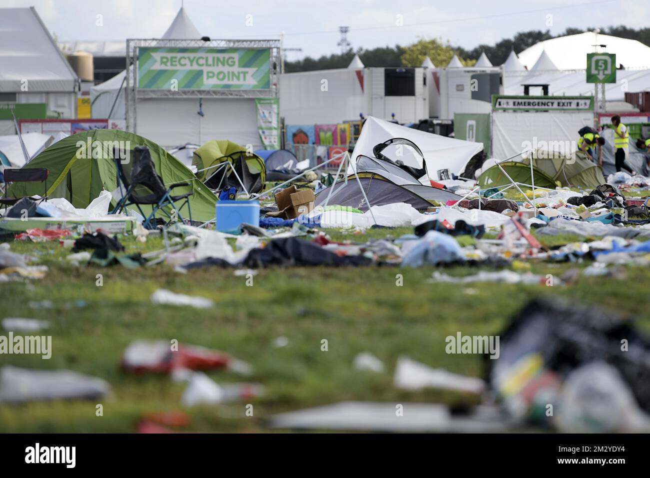 Illustration shows abandoned tents and garbage in front of a 'recycling ...