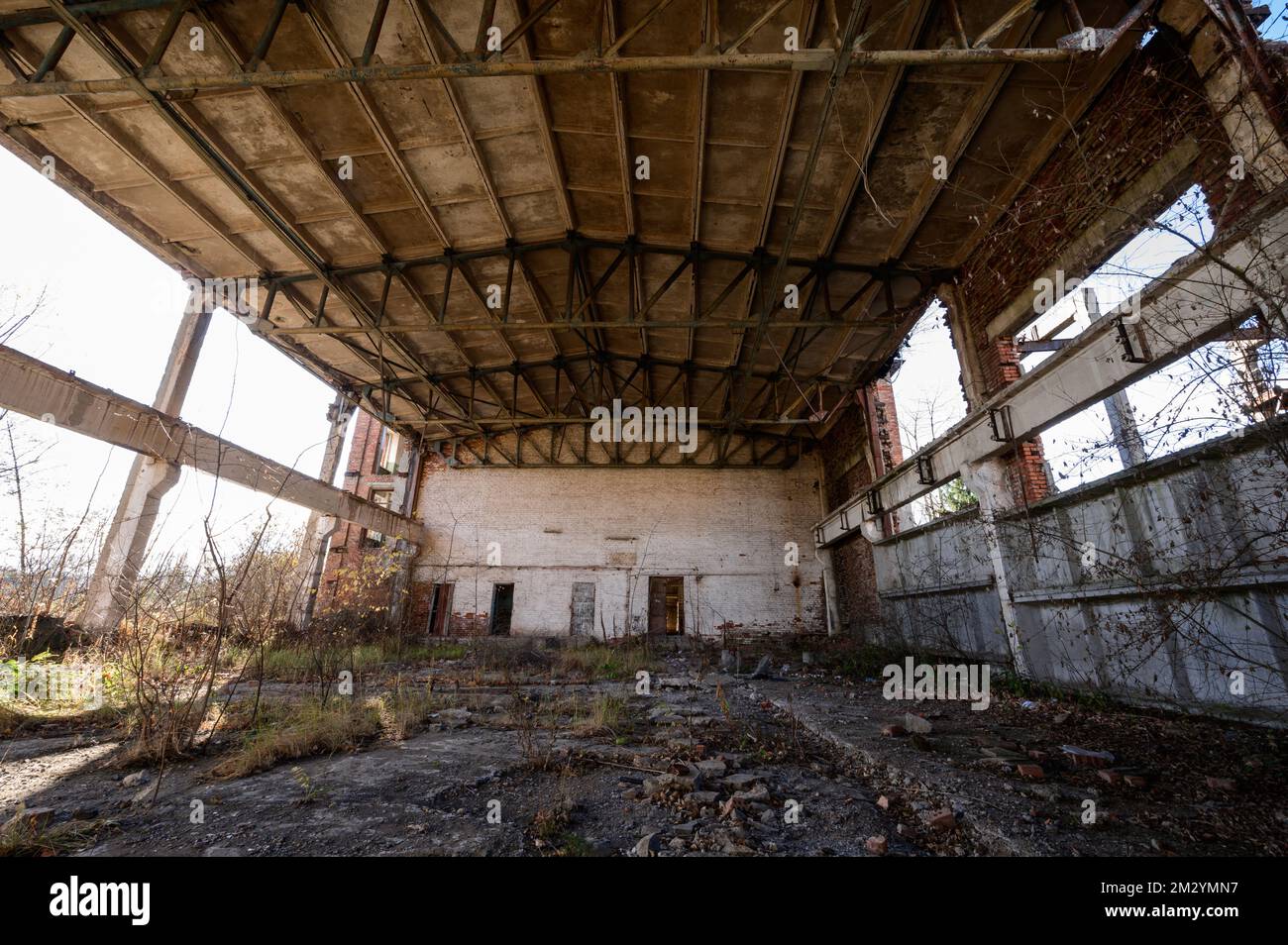 An abandoned warehouse that has been destroyed by people and time, a ...