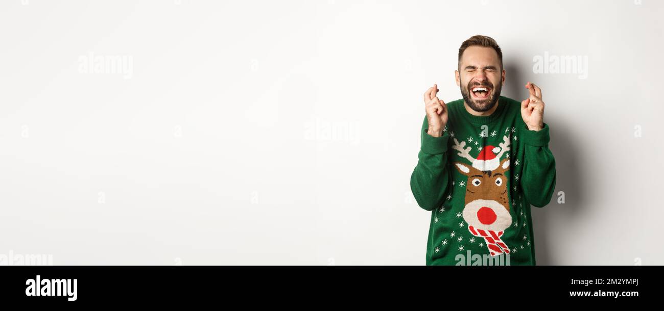 Christmas, holidays and celebration. Hopeful and excited guy making ...