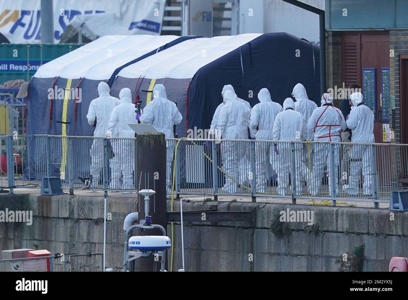 Police Forensic officers head to the forensic tents erected at the RNLI ...