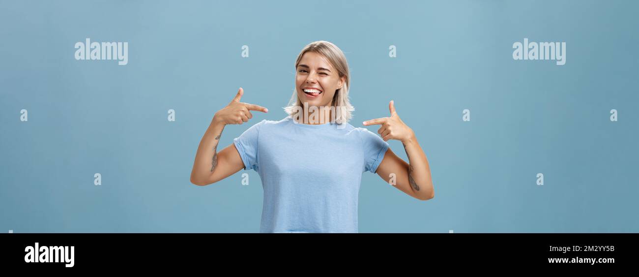 Girl proudly indicates at herself bragging with own achievements ...