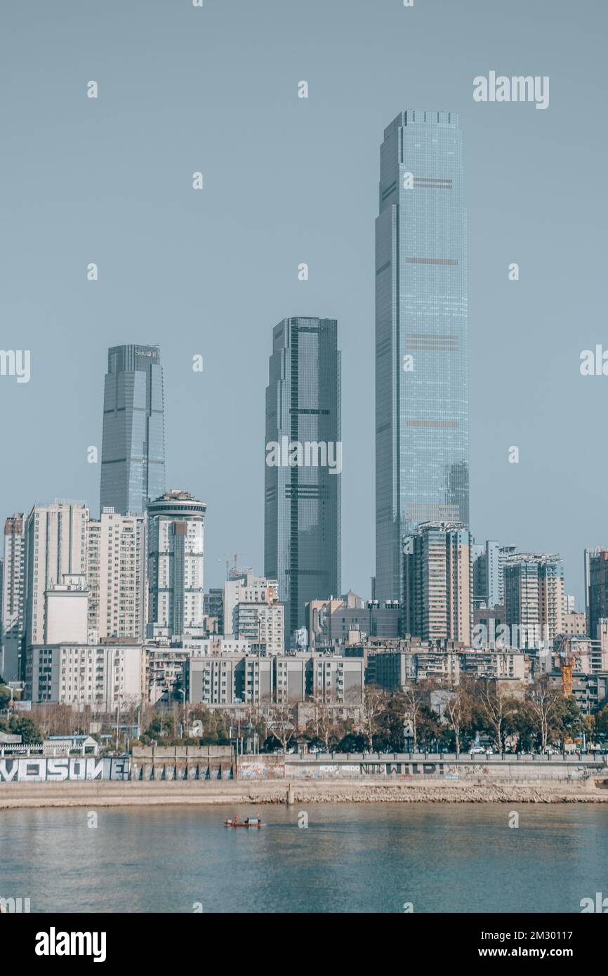 The vertical view of waterside buildings in Changsha before a blue ...