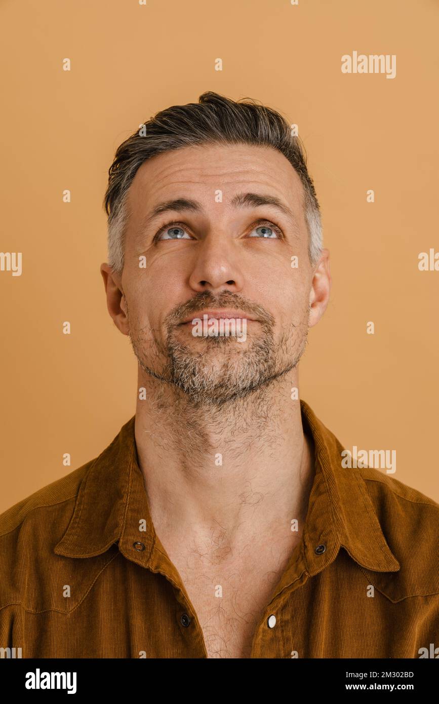 White grey man wearing shirt posing and looking upward isolated over ...