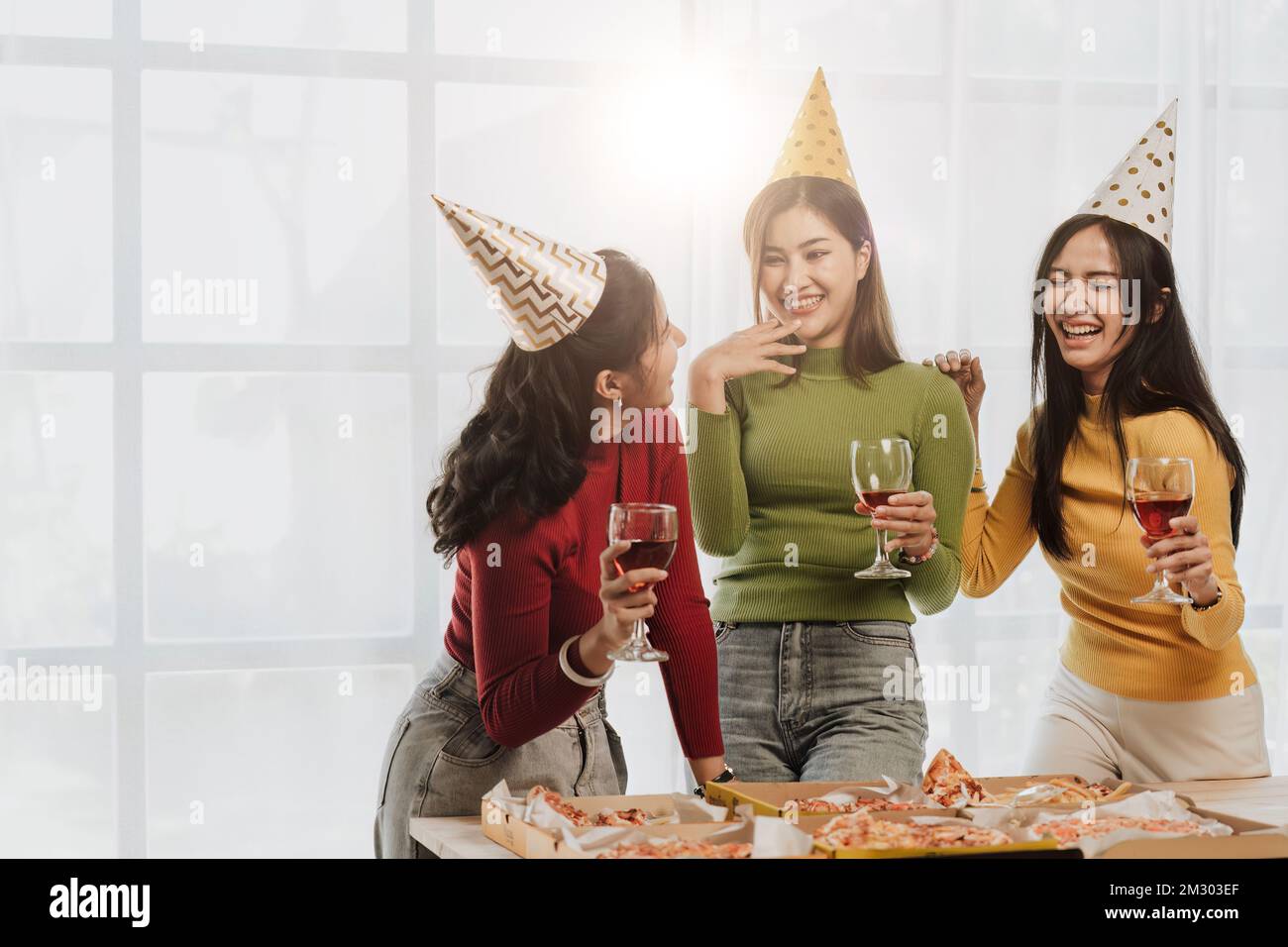 Group of Asian friends gather to celebrate Christmas with champagne and ...