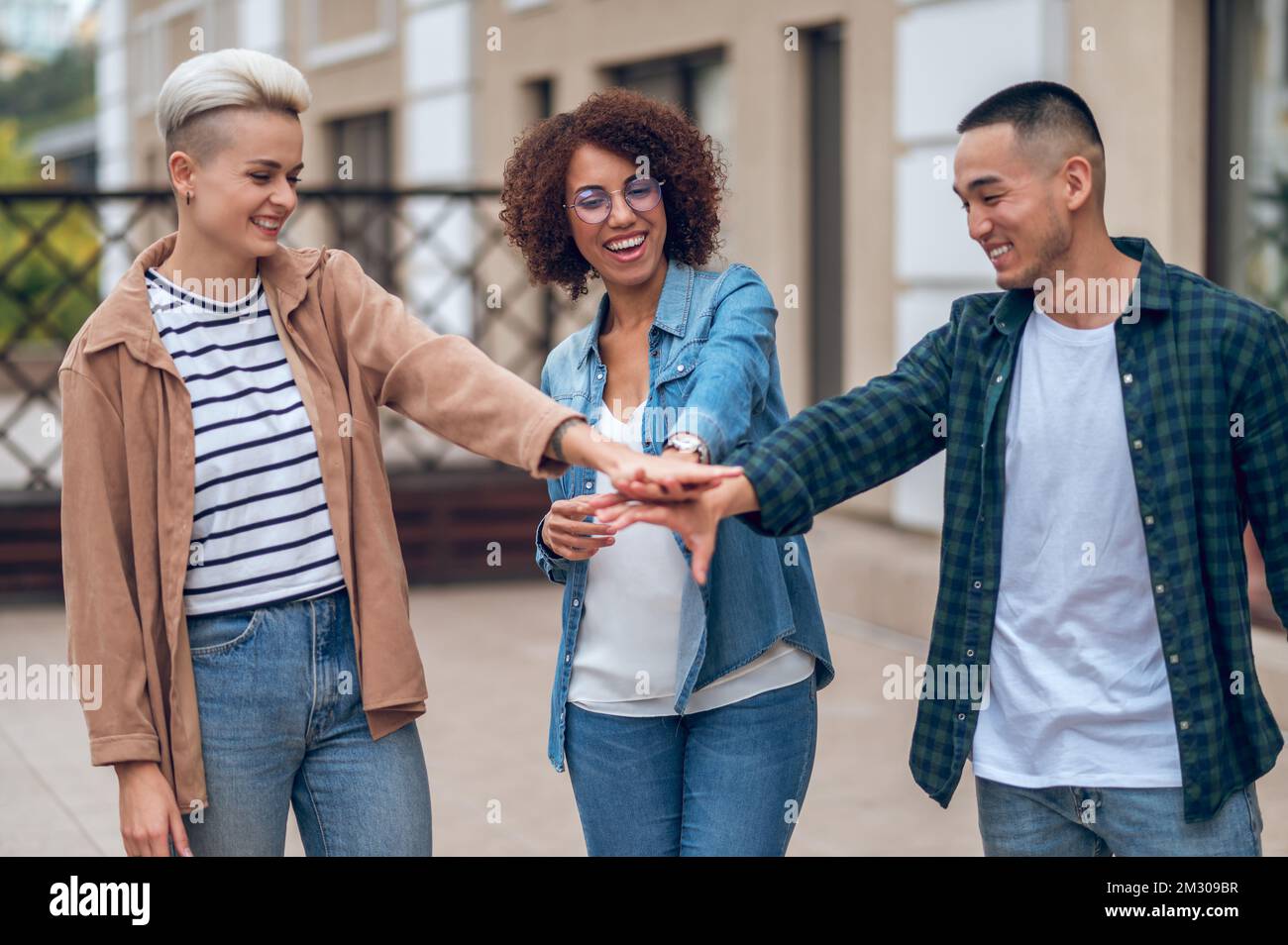 Group of three people showing their support for each other Stock Photo ...