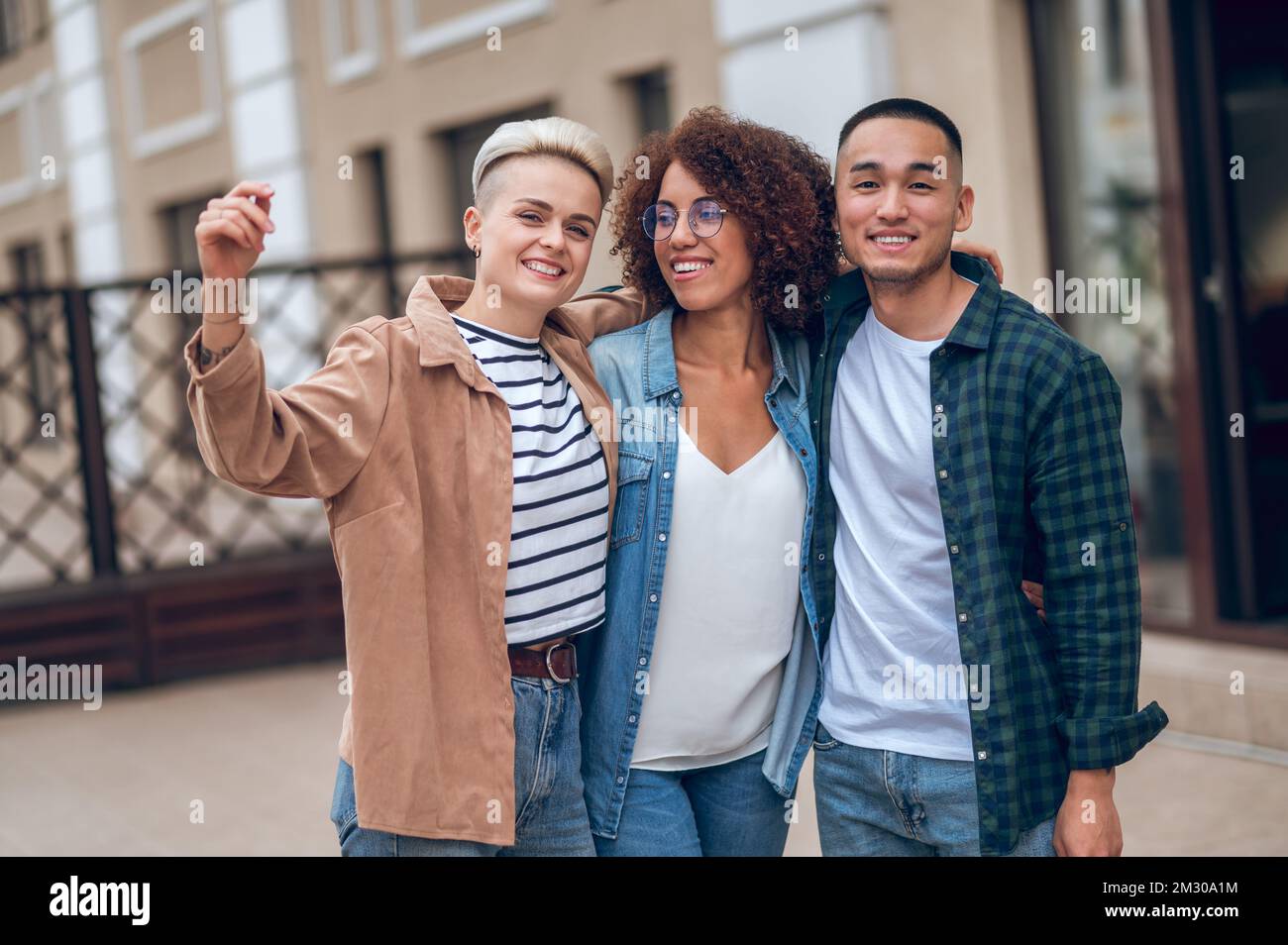Cheerful multinational friends looking on hi-res stock photography and ...