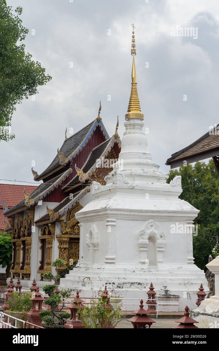 View of beautiful white ancient Lanna style stupa or chedi with golden ...