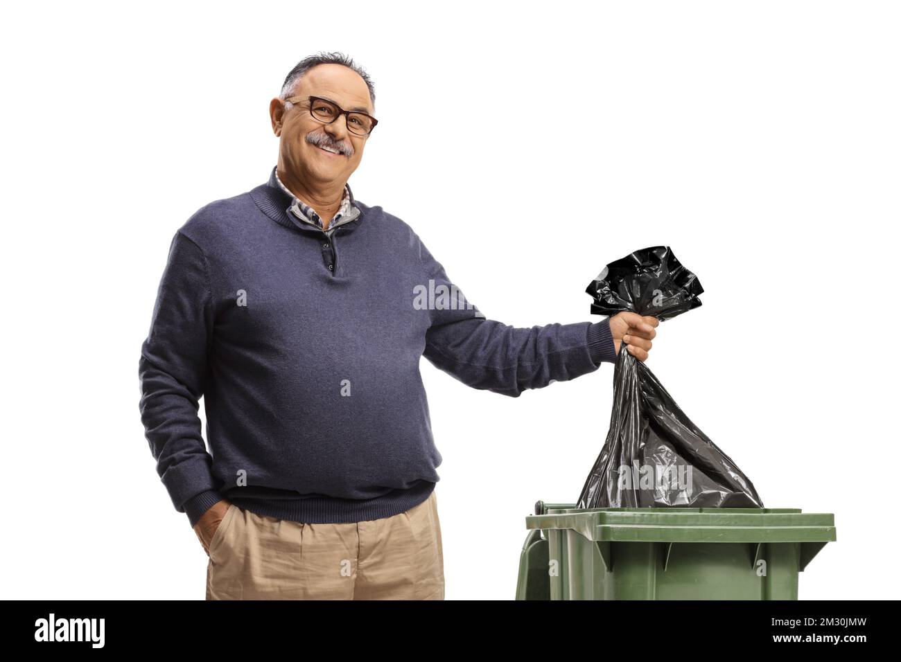 Mature man throwing a plastic bag in a bin isolated on white background ...