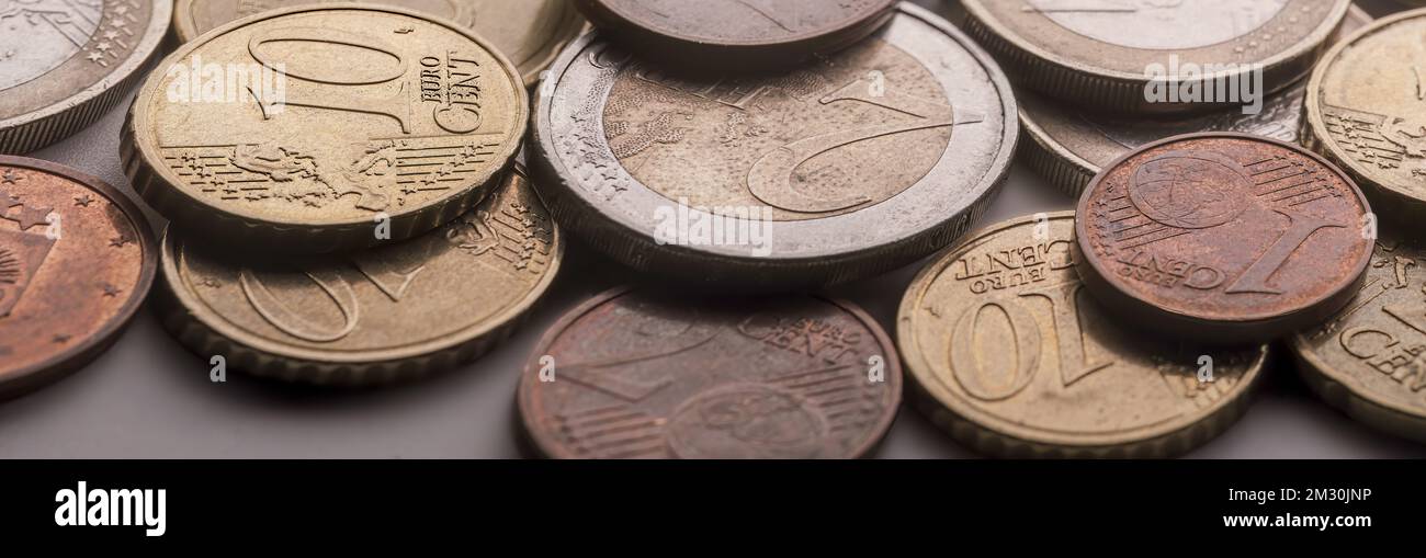 A pile of coins on the table of different denominations. Background of ...