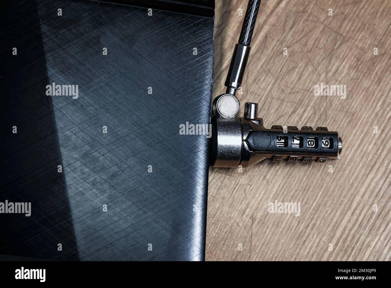 Laptop locked with cable lock. Security concept. Kensington Security ...